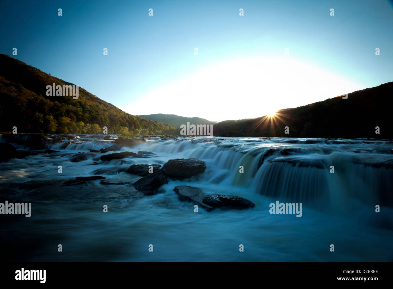 Wide waterfall seen in evening light with blurry water Stock Photo - Alamy