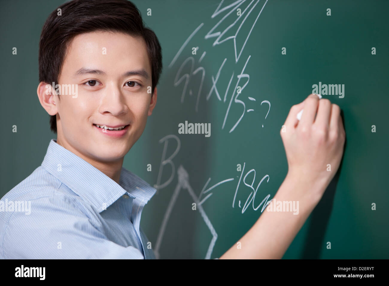 Professional male teacher writing on blackboard Stock Photo - Alamy Professional male teacher writing on blackboard Stock Photo - Alamy
