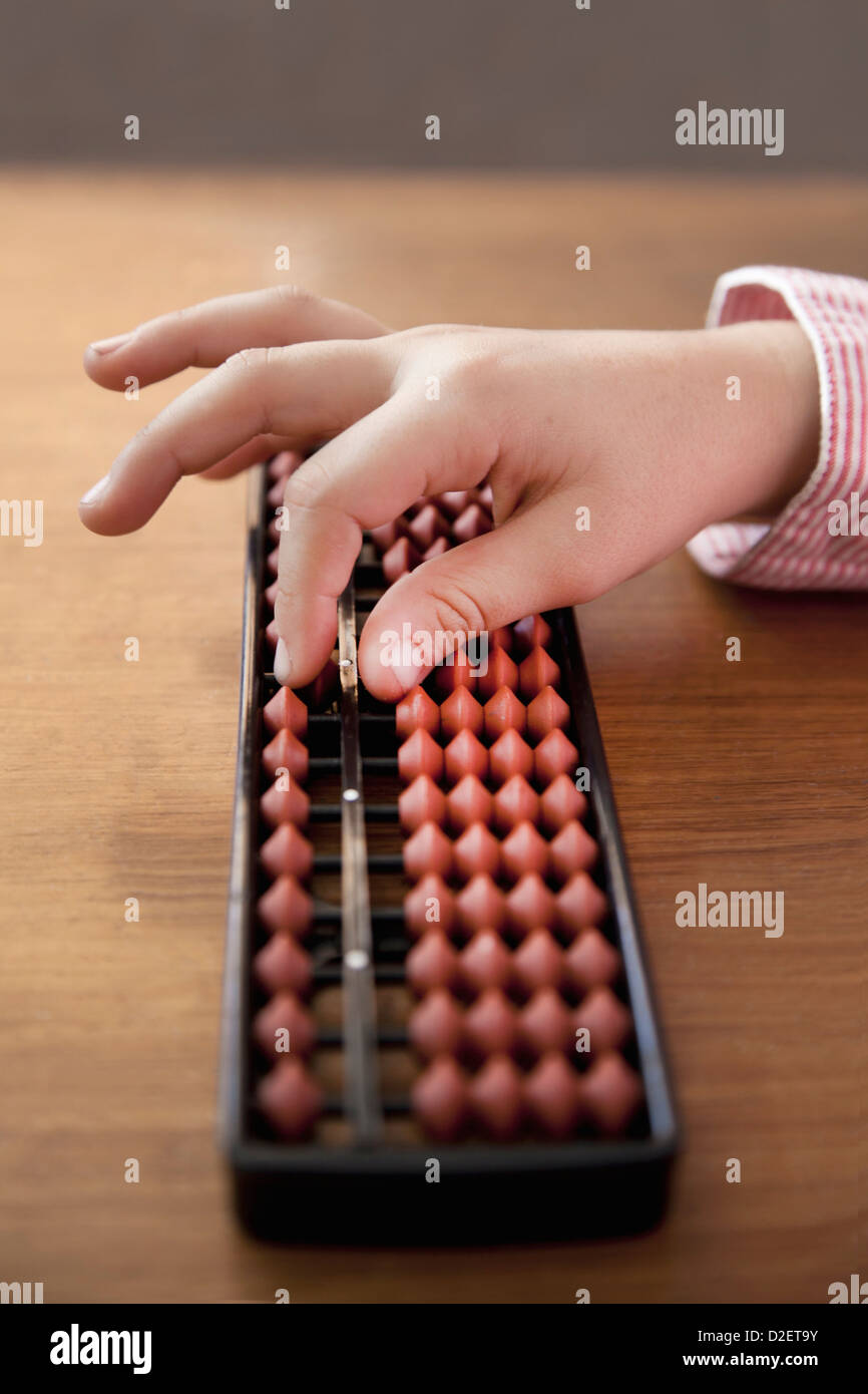 Child's hand using a Japanese abacus (soroban) also known as counting ...