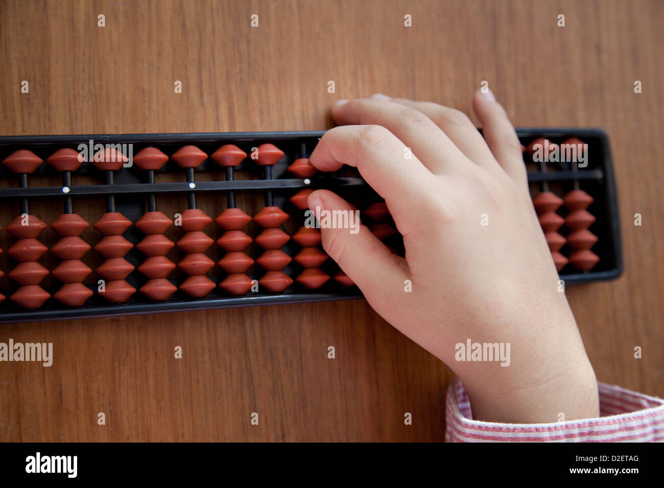 Child's hand using a Japanese abacus (soroban) also known as counting ...