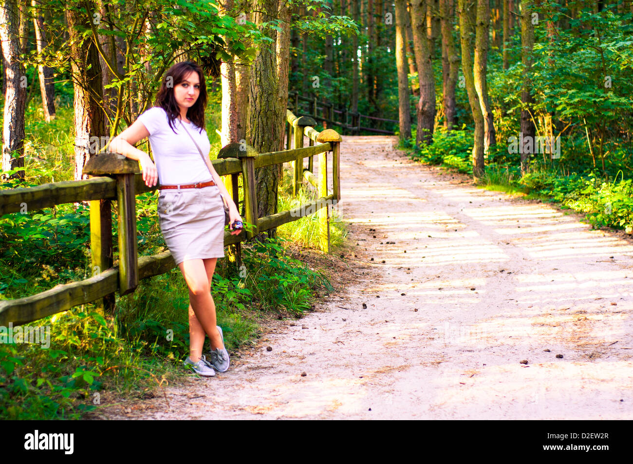 An image o girl walking through the forest pathway Stock Photo - Alamy