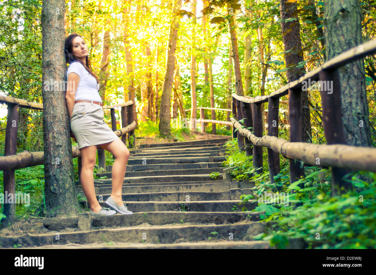An image o girl walking through the forest pathway Stock Photo - Alamy