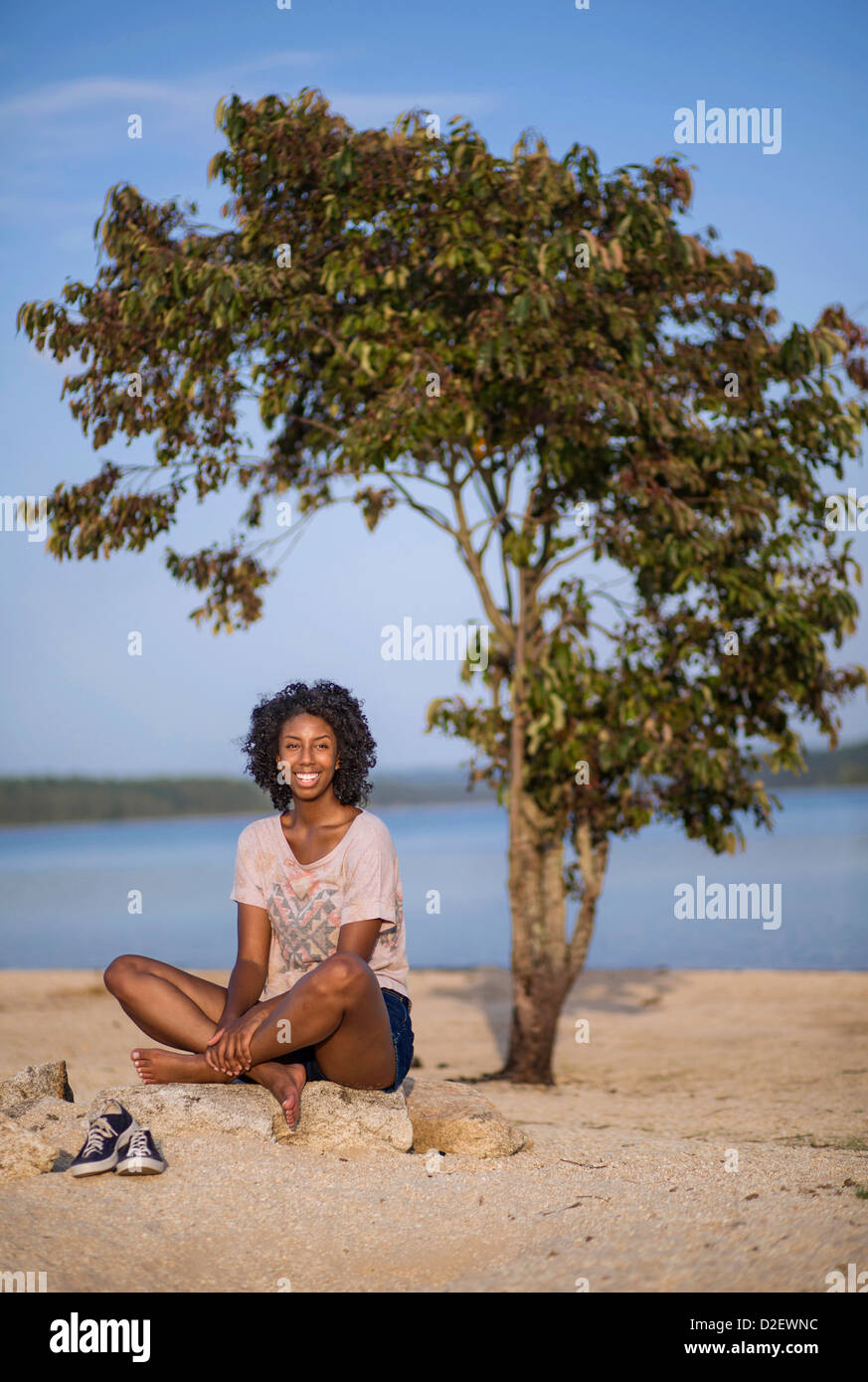 A young woman relaxes on a sandy beach at Lake Wedowee, Alabama Stock ...