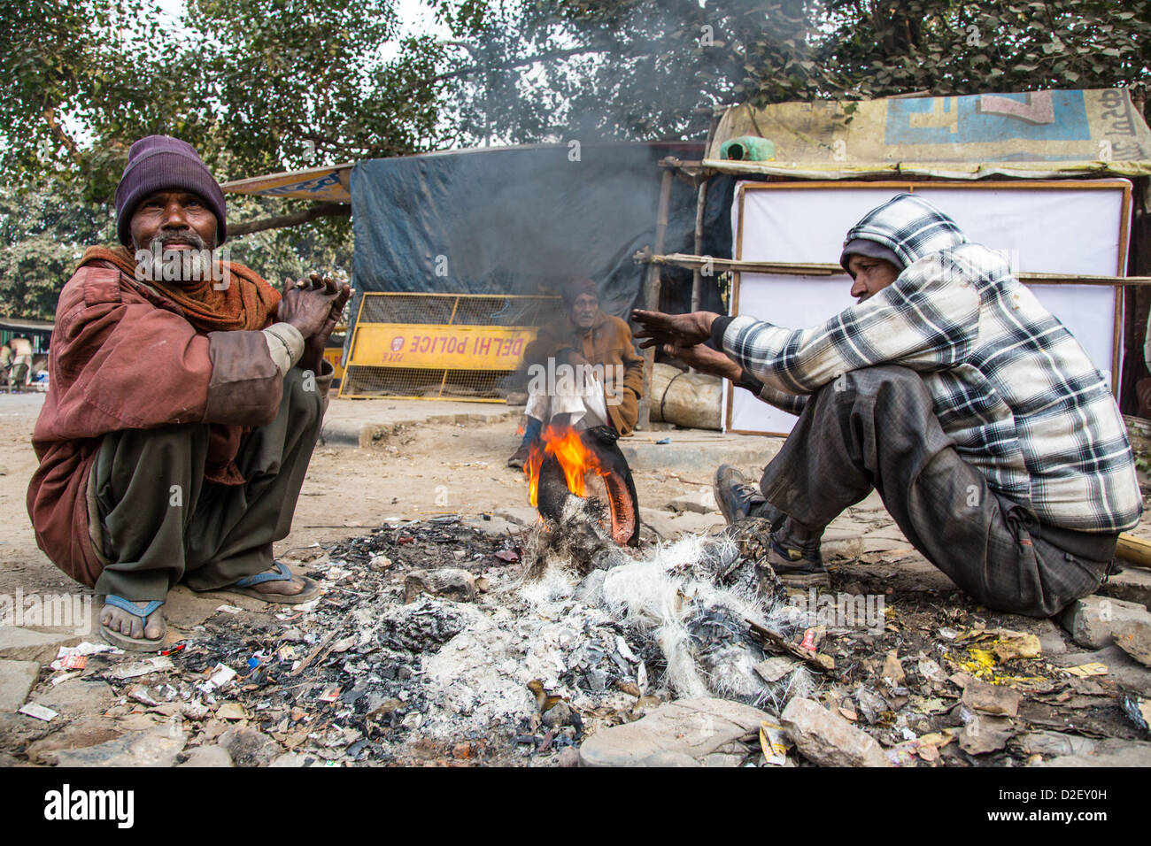 Homeless warming themselves next to a fire, Delhi, India Stock Photo ...