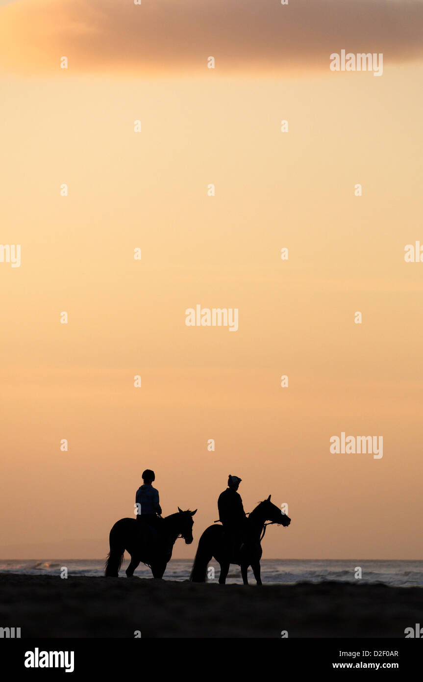 Riding horses at sunset hi-res stock photography and images - Alamy
