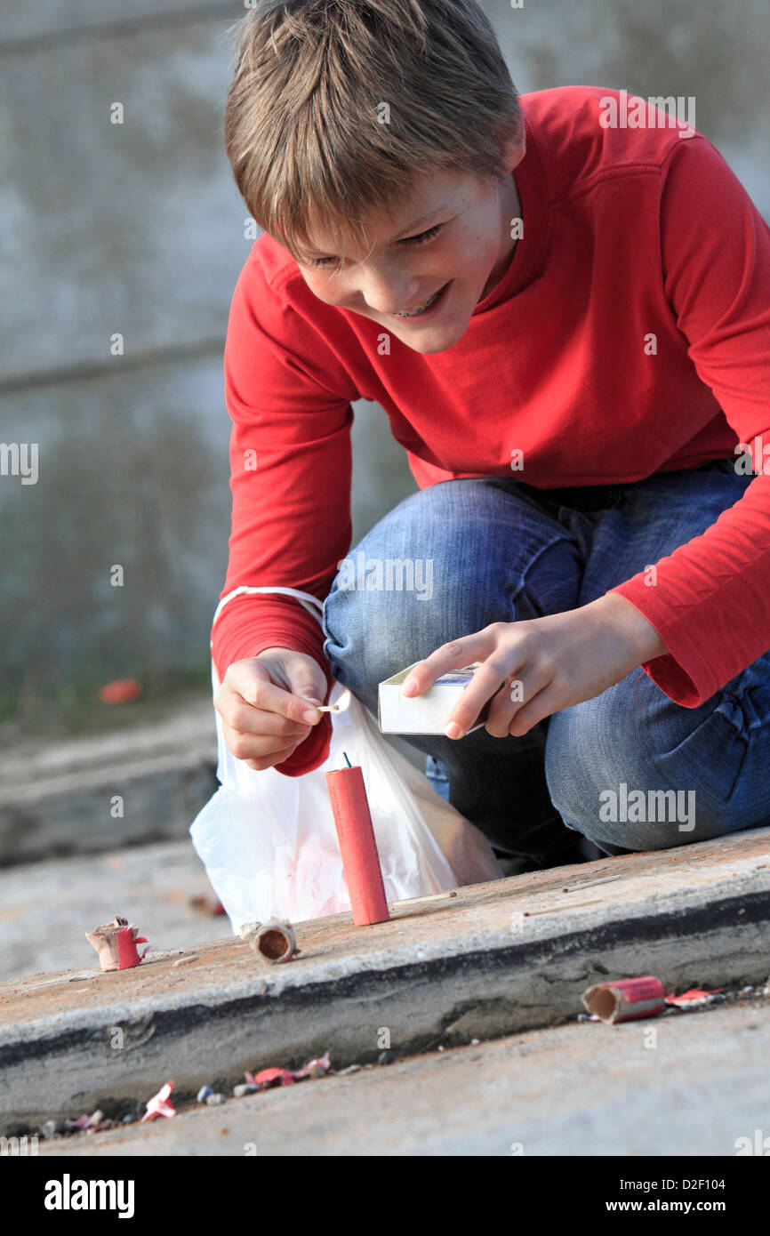 France, young boy playing with firecrackers Stock Photo - Alamy