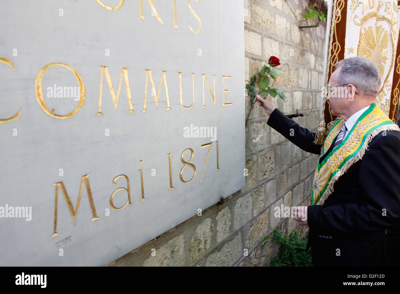 Freemason placing a rose on the Mur des Federes in the Pere Lachaise ...