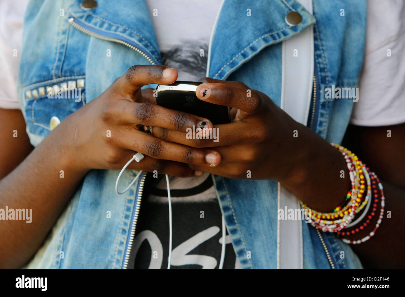 Girl playing music on a mobile phone Stock Photo - Alamy