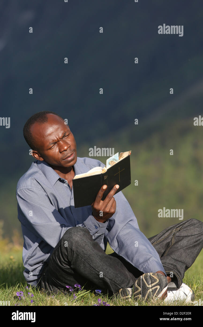 Man reading the bible outside. France Stock Photo - Alamy