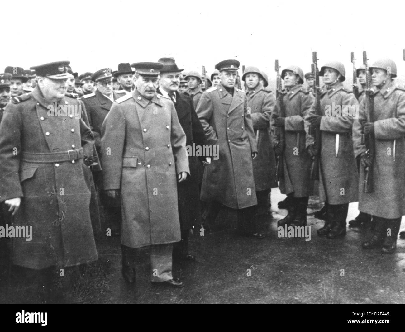 JOSEPH STALIN leads Winston Churchill past a guard of honour as the ...