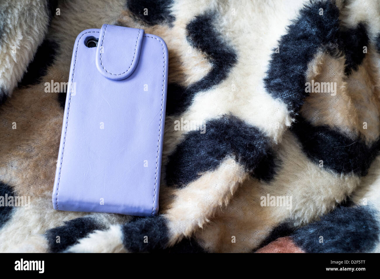 Mobile phone case placed on a patterned blanket Stock Photo - Alamy