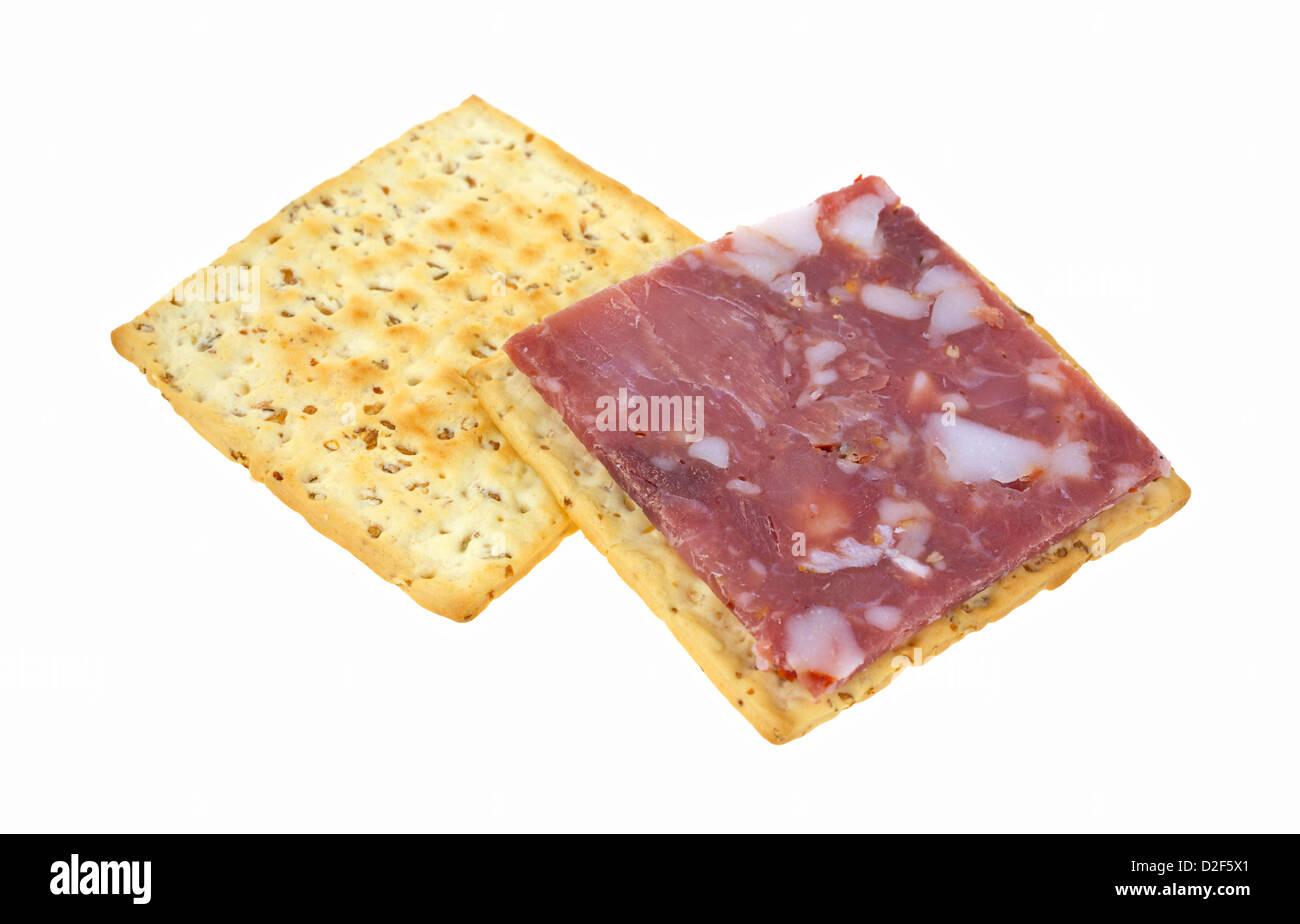 Two whole wheat crackers with one topped with sopressata salami on a ...