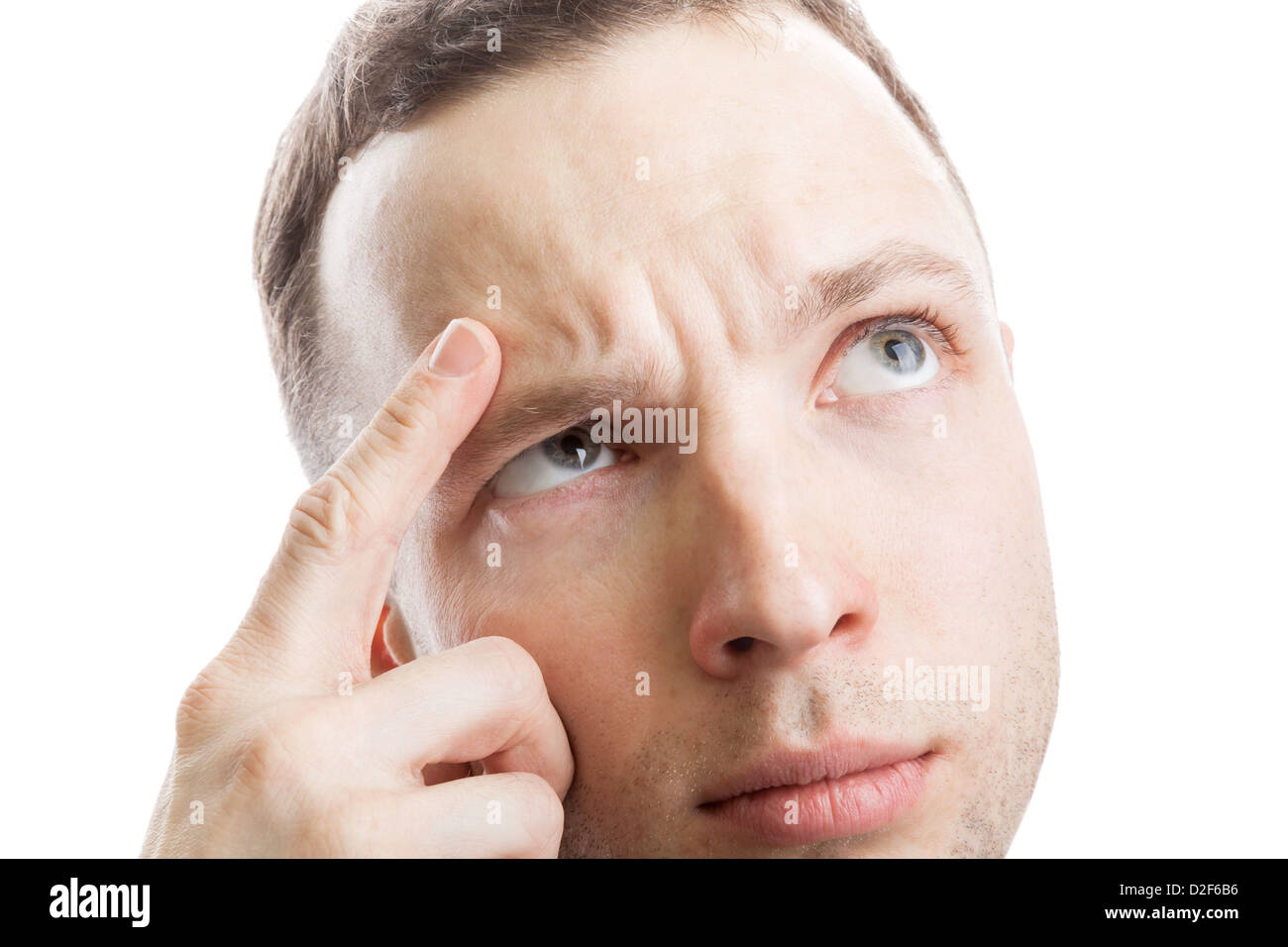 Young Caucasian man thinking, closeup studio portrait isolated on white ...