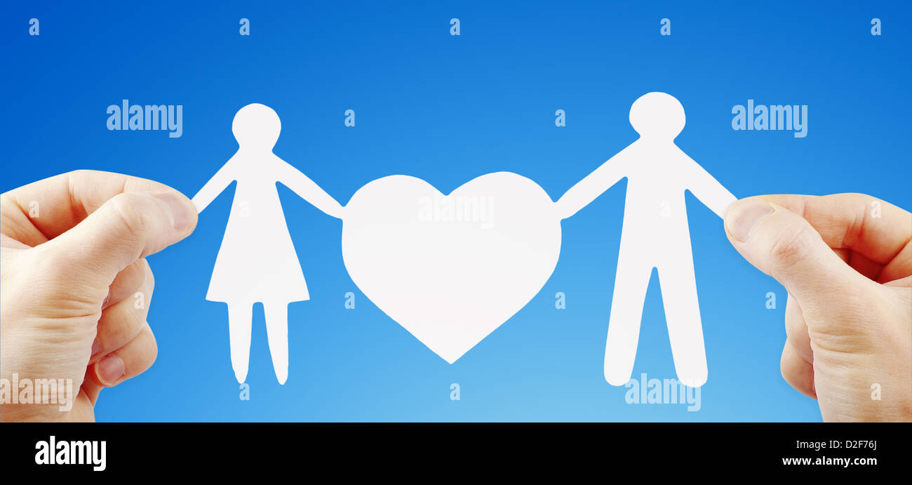 paper family with heart in hands Stock Photo - Alamy