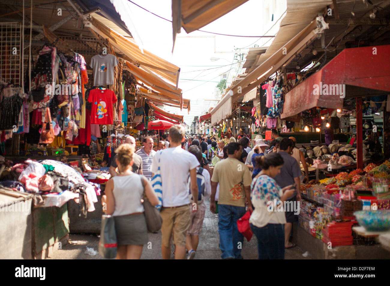 People walk through a market in Tel Aviv, Israel, the day before ...