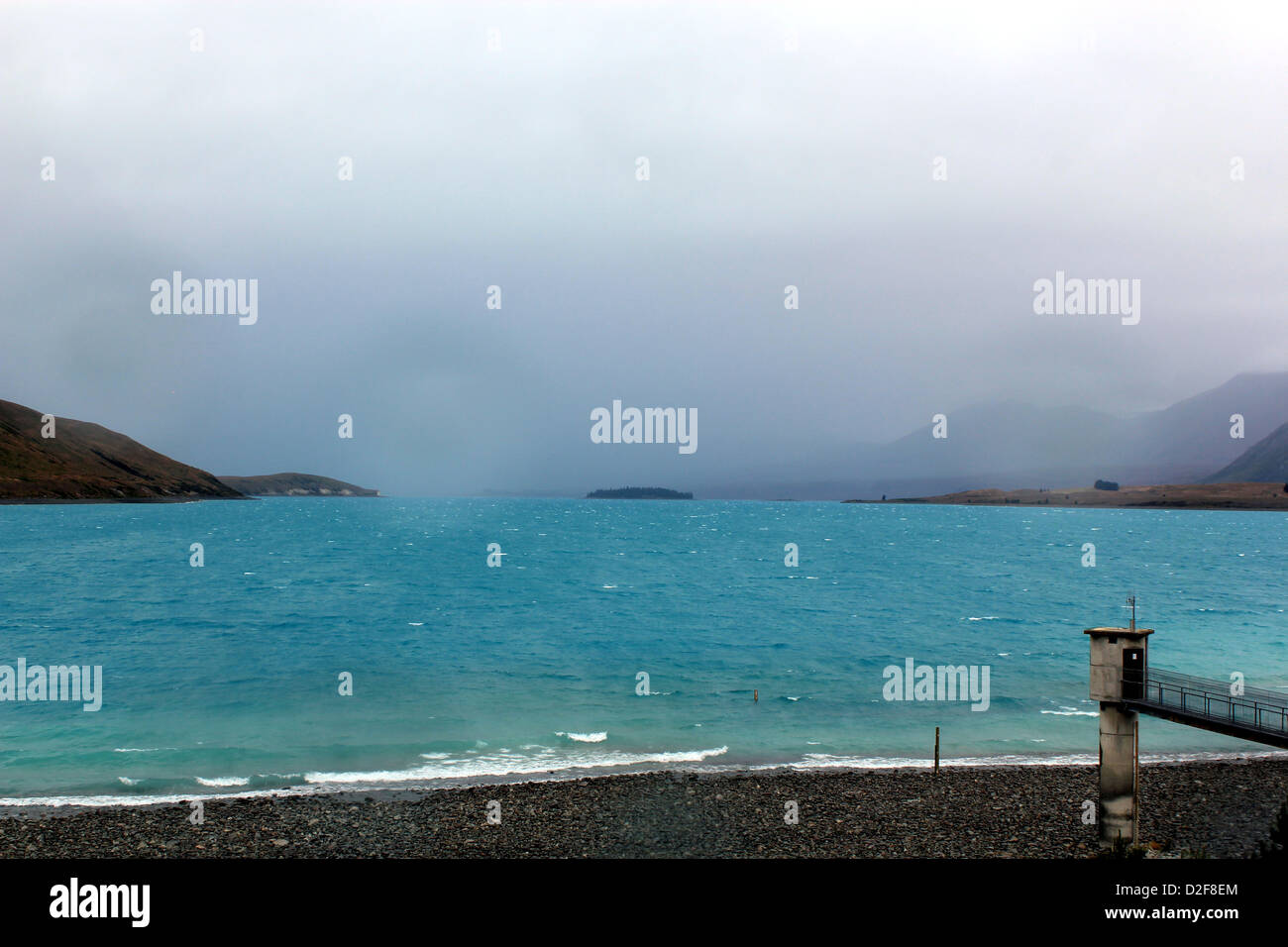 Blue lake with observation desk,hazy mountains Stock Photo - Alamy