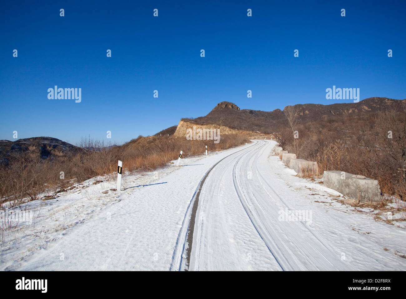 Winding road through snow covered winter landscape hi-res stock ...