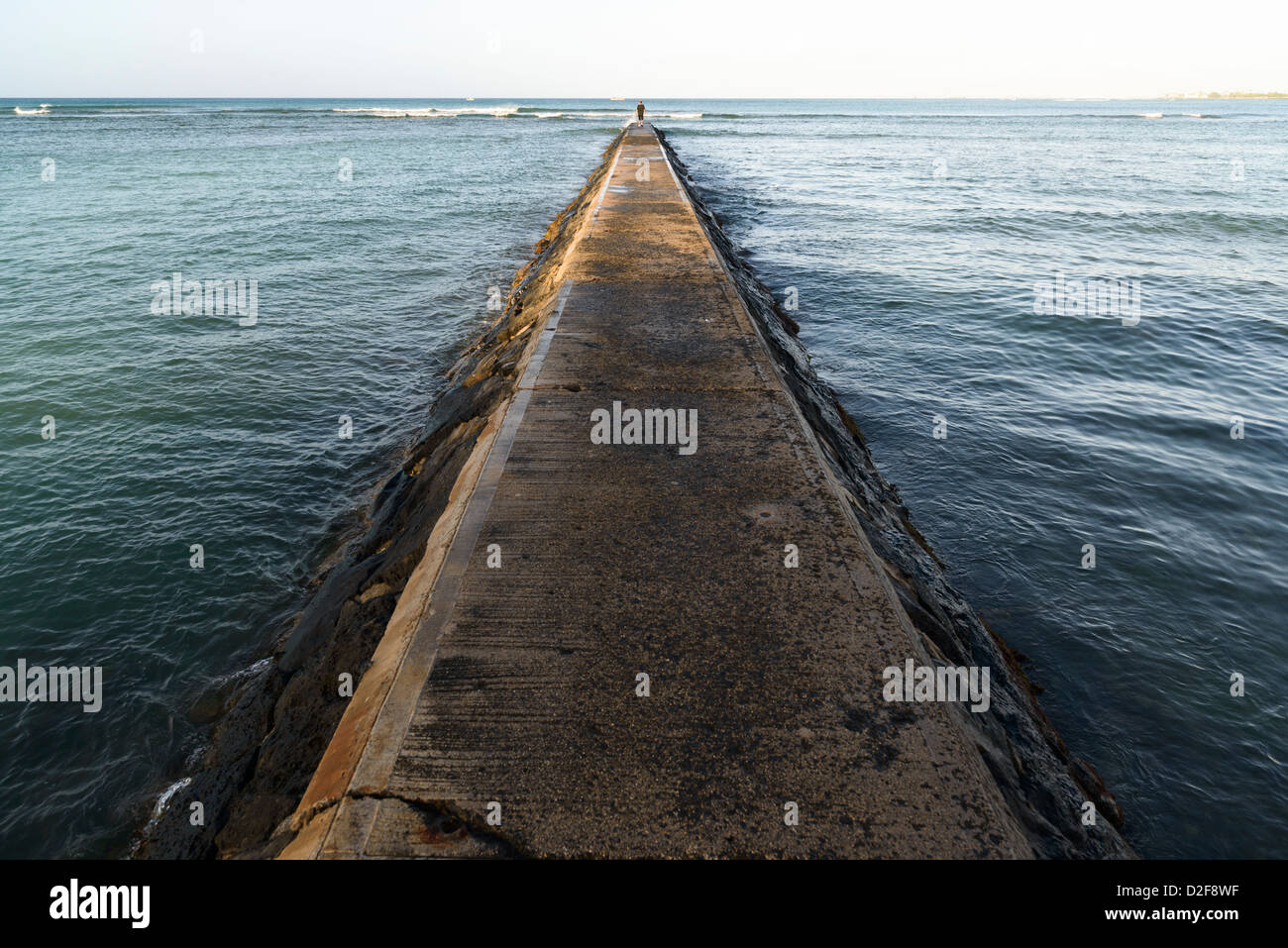 Man at the end of a concrete pier, Waikiki Beach, Oahu, Honolulu ...
