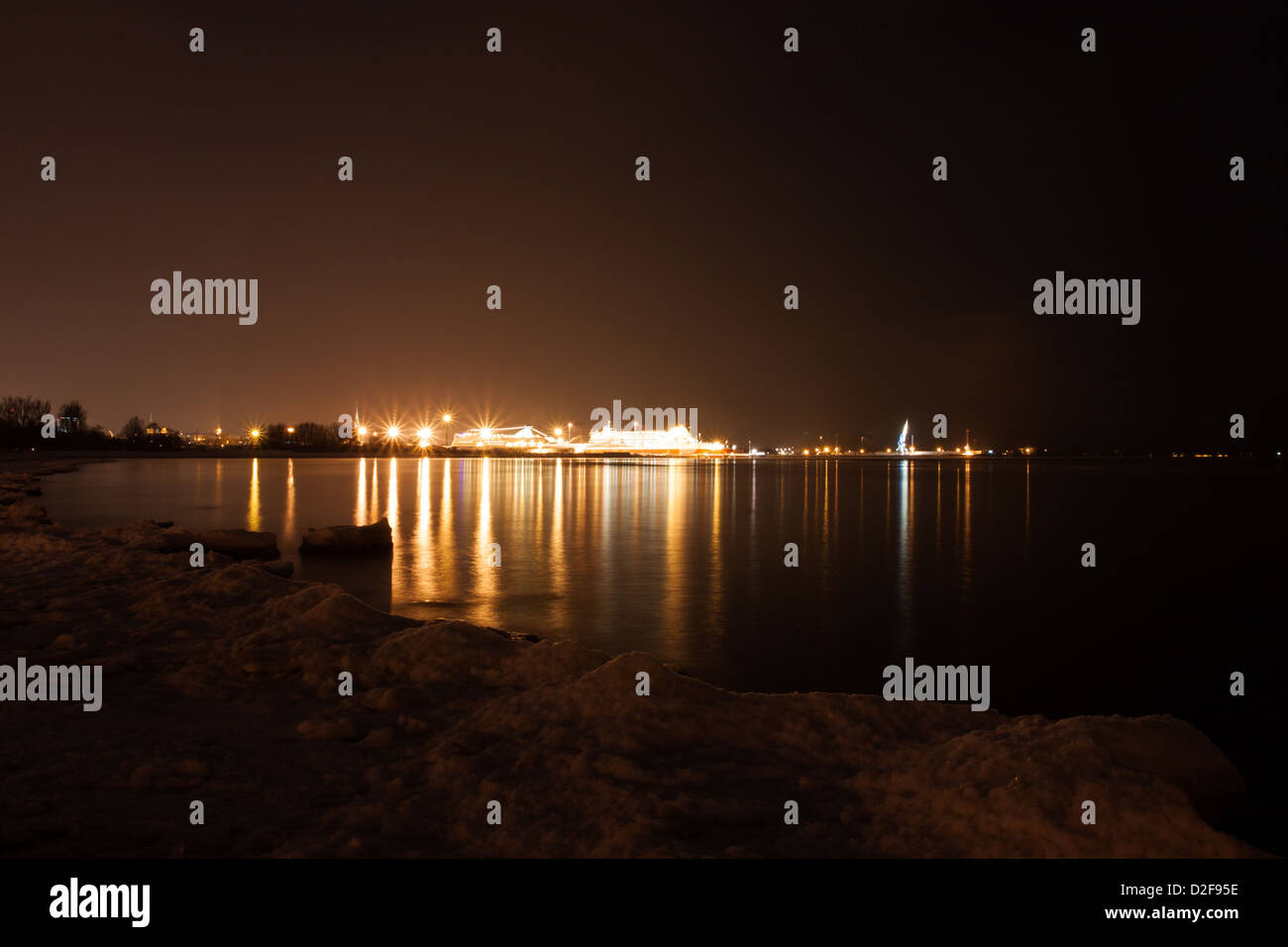 View on Tallinn winter sea port at night with ship Stock Photo - Alamy