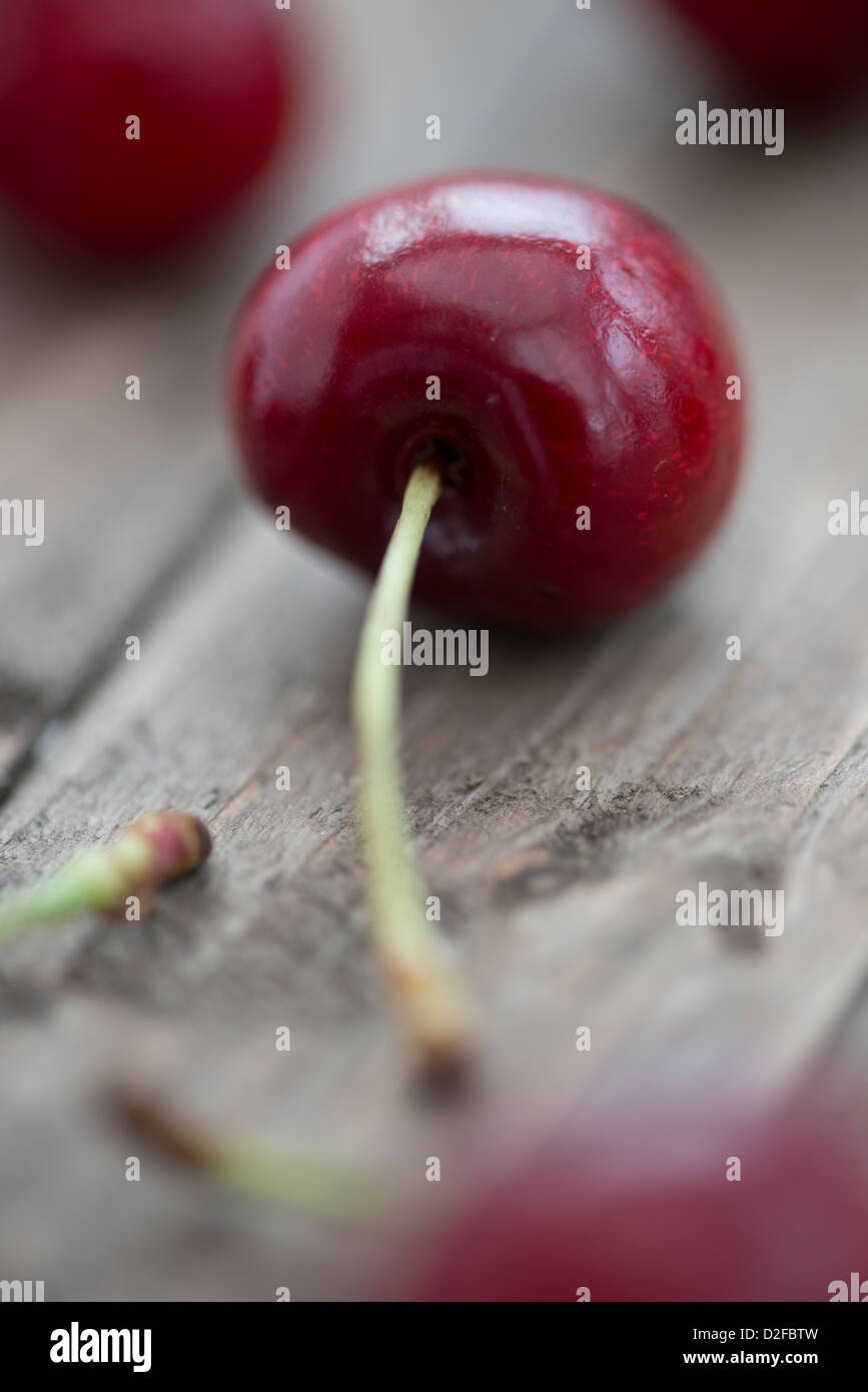 Cherries on a wooden table Stock Photo - Alamy