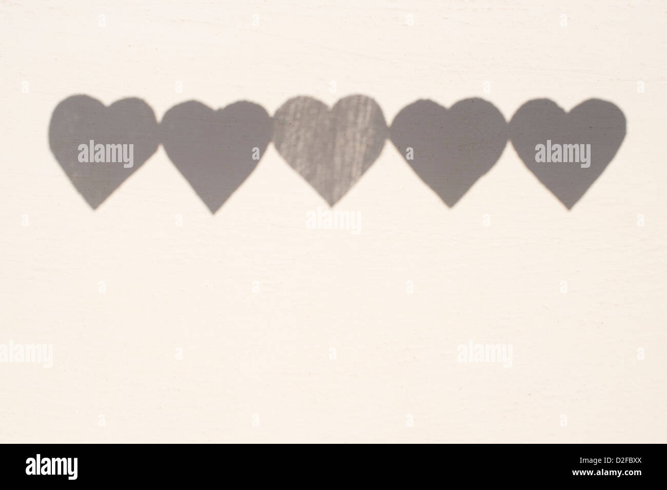 Line of heart shape shadows on white Stock Photo - Alamy
