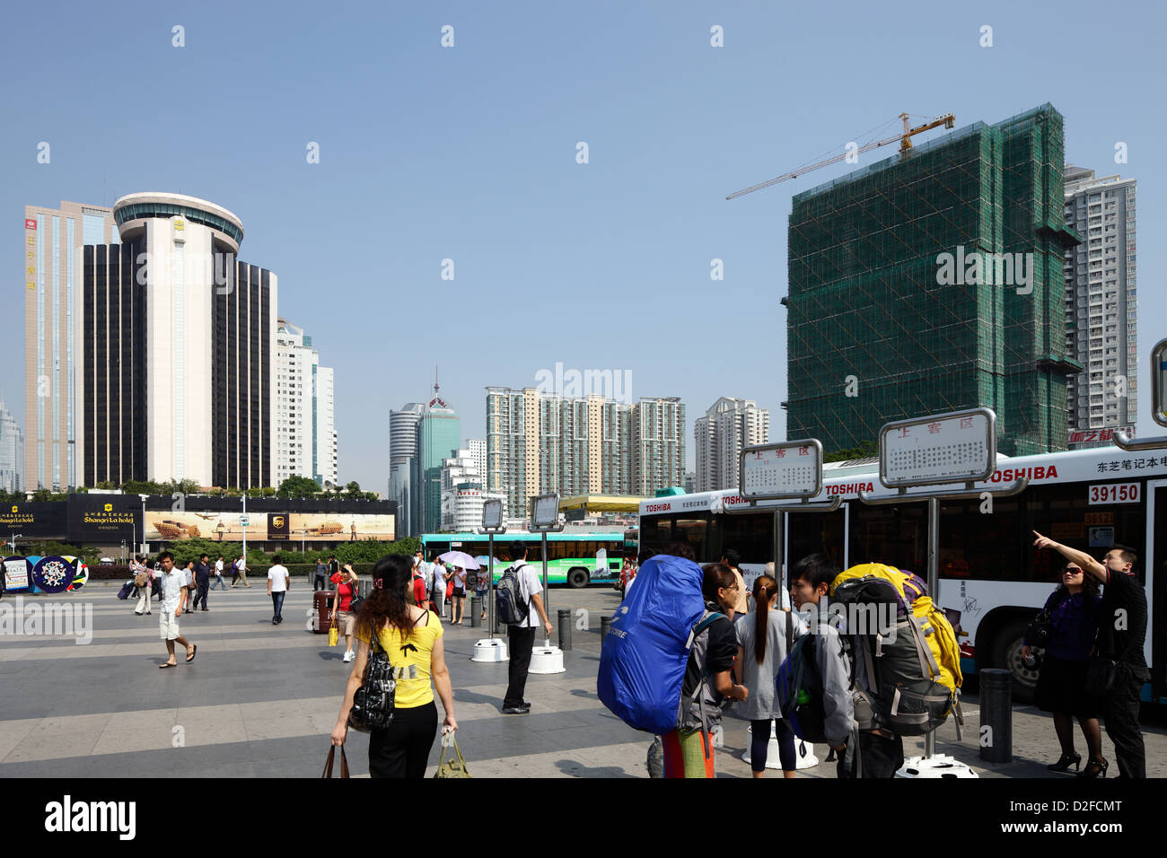 Shenzhen, China, pedestrians and backpackers at the bus station in the ...