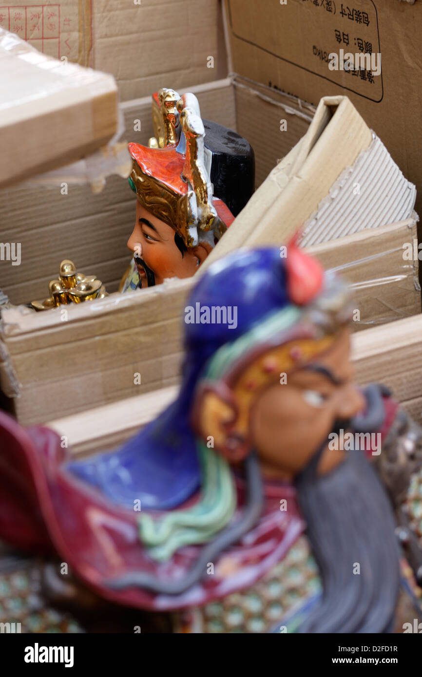 Shenzhen, China, in torn cardboard figures stand in costumes of Chinese ...
