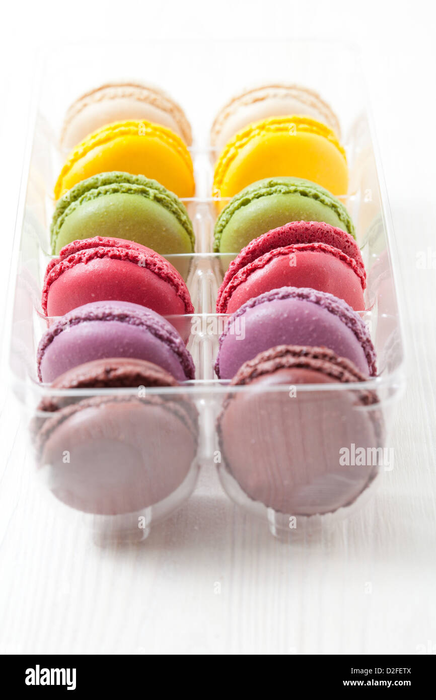 Assortment of colorful macaroons in tray on light background Stock ...