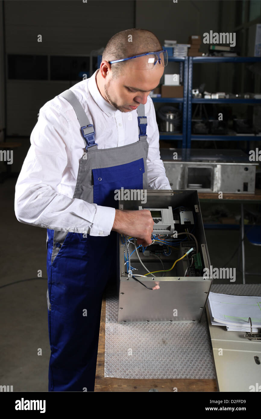 workman in blue overalls Stock Photo - Alamy