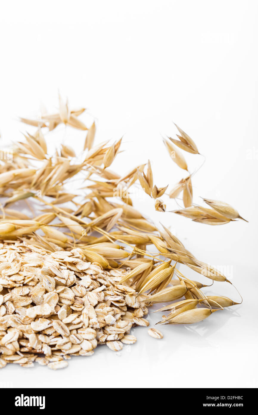 Oat flakes heap isolated on white background Stock Photo - Alamy