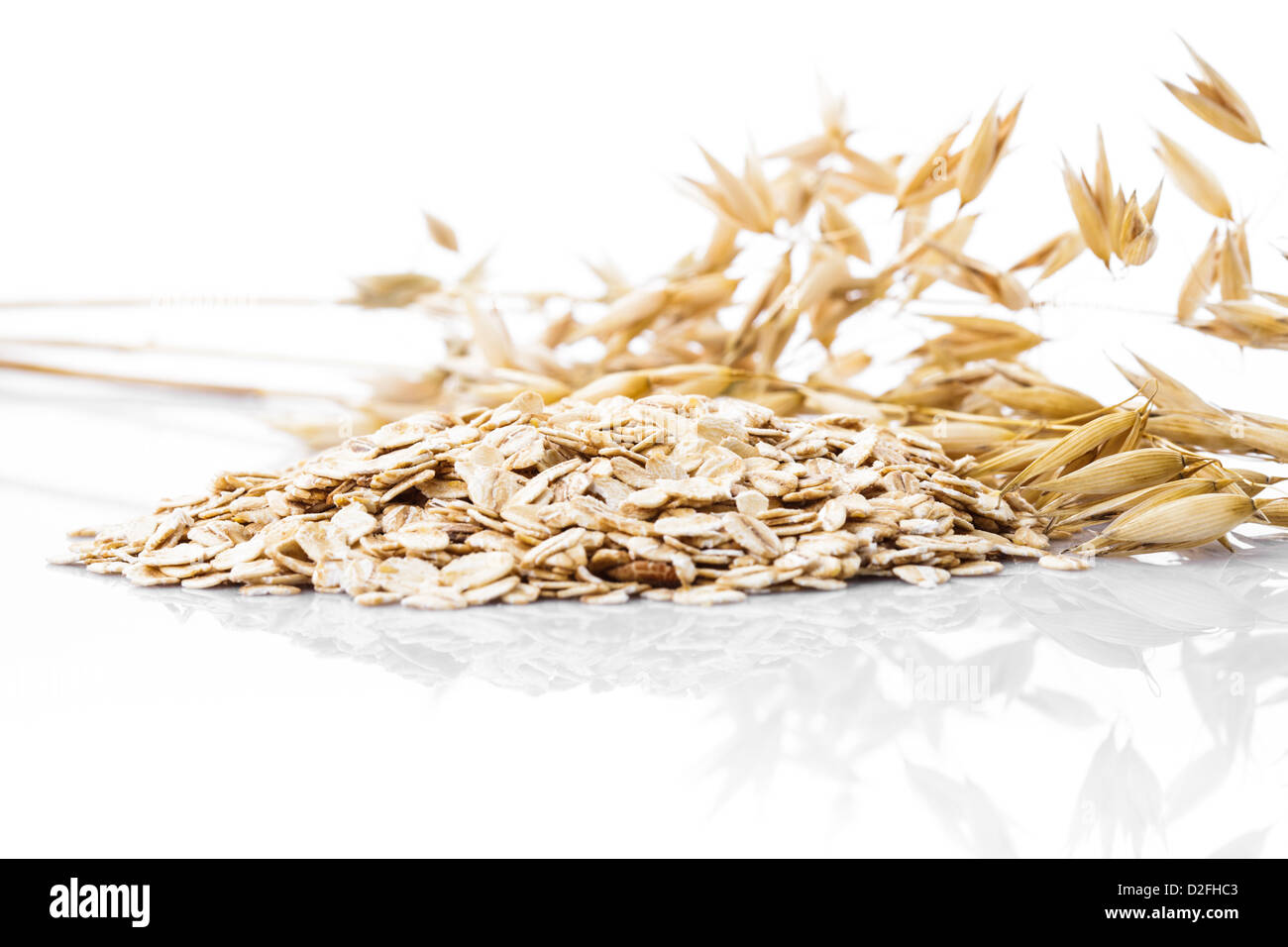 Oat flakes heap isolated on white background Stock Photo - Alamy