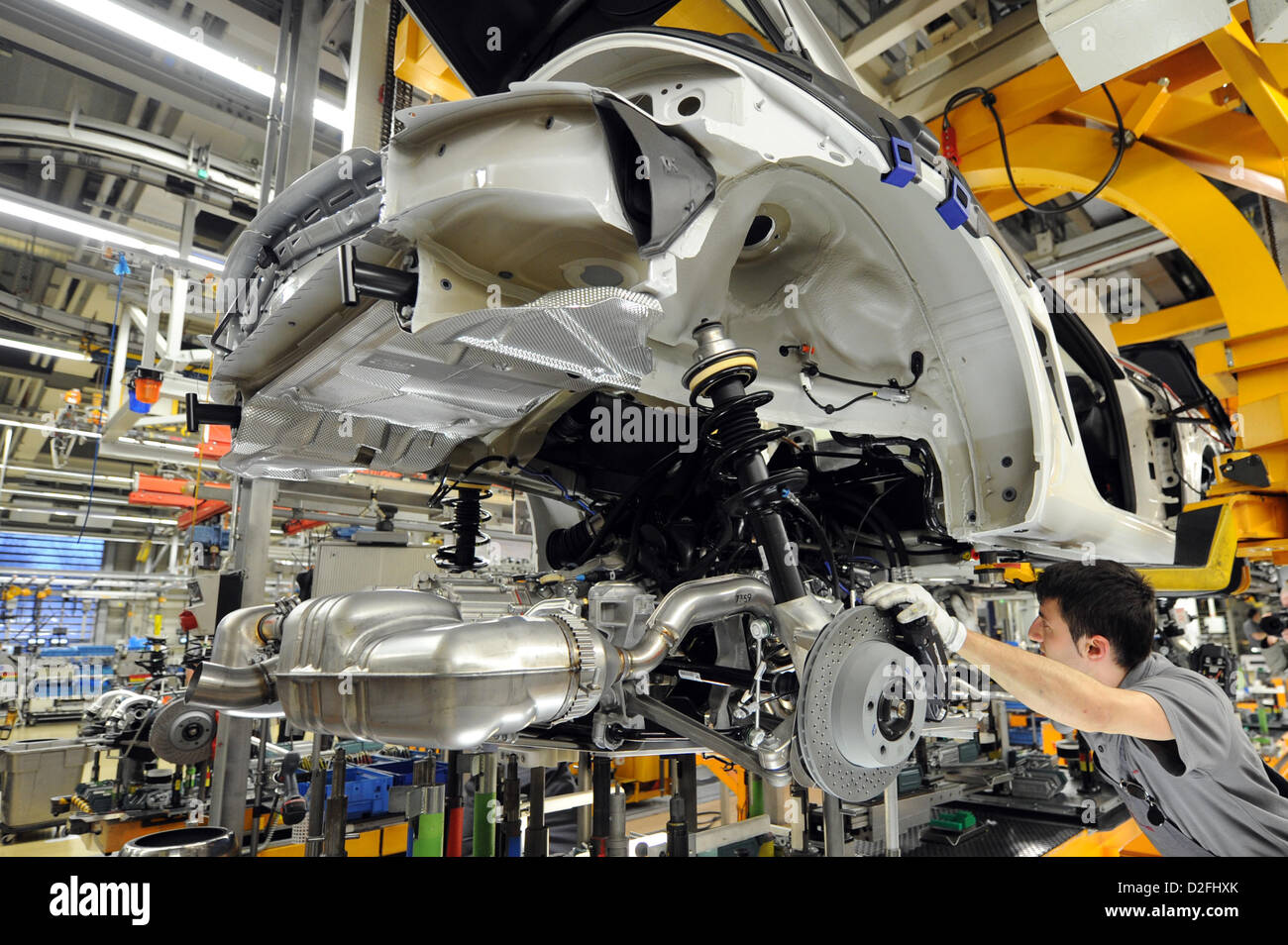 A worker of Porsche AG works at the assembly line of the model Porsche ...