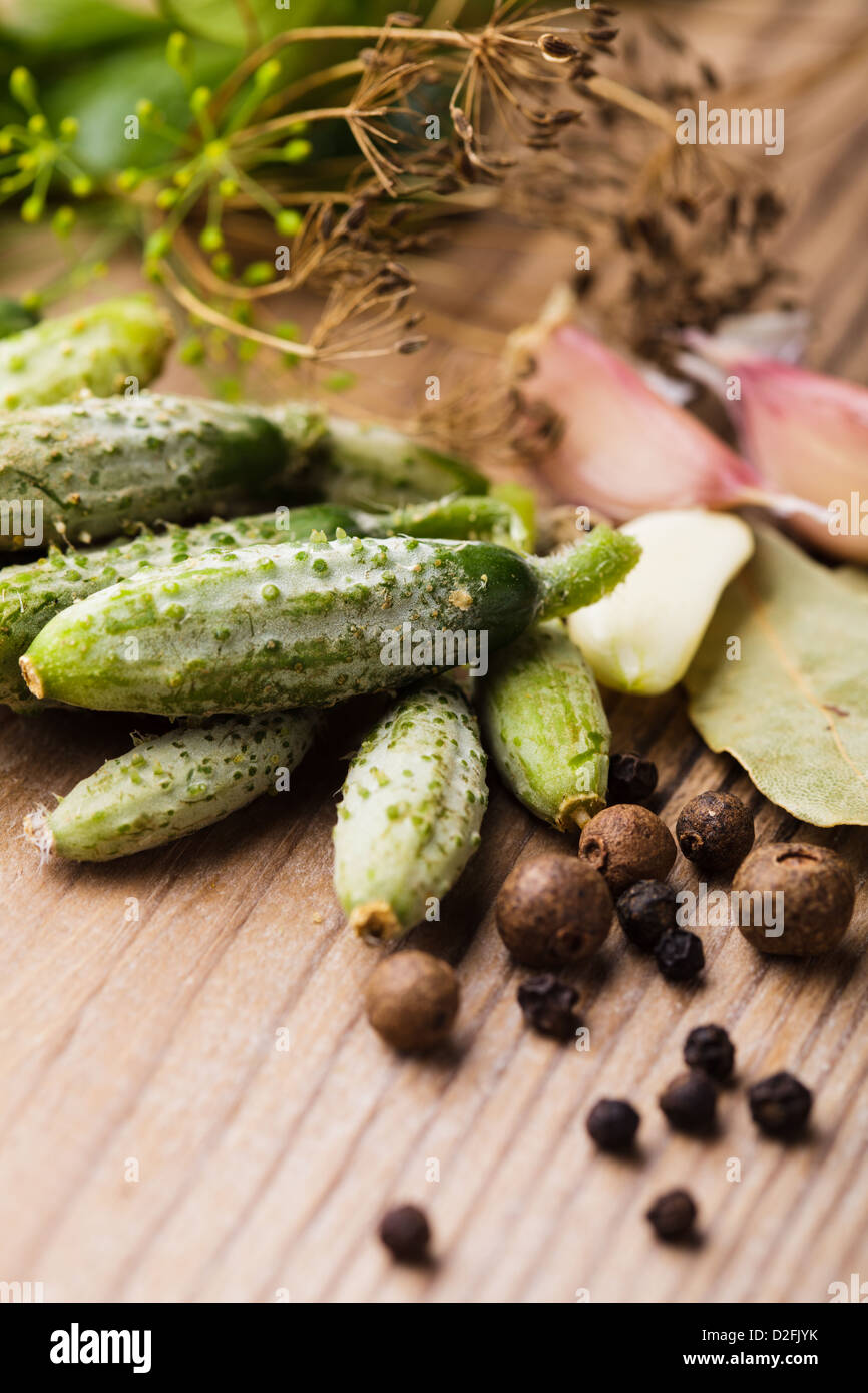 Preparation of small cucumber preserving on wooden table Stock Photo ...