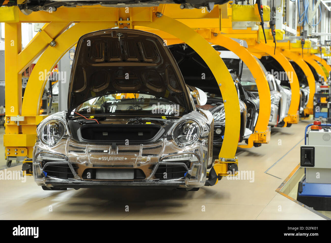 Employees of Porsche AG work at the assembly line of the model Porsche ...