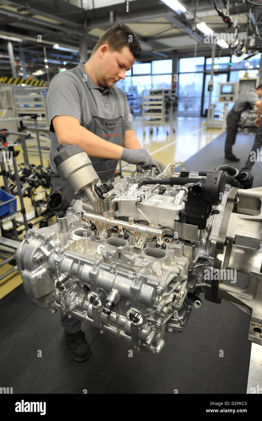 An employee of Porsche AG puts together a boxer engine for a Porsche ...
