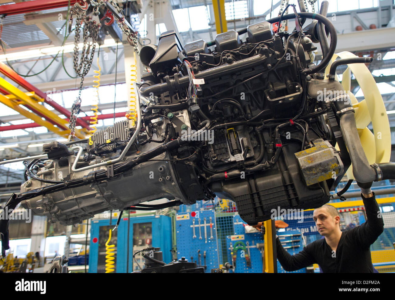 An employee is installing the engine of a truck, on 8 February 2012, at ...