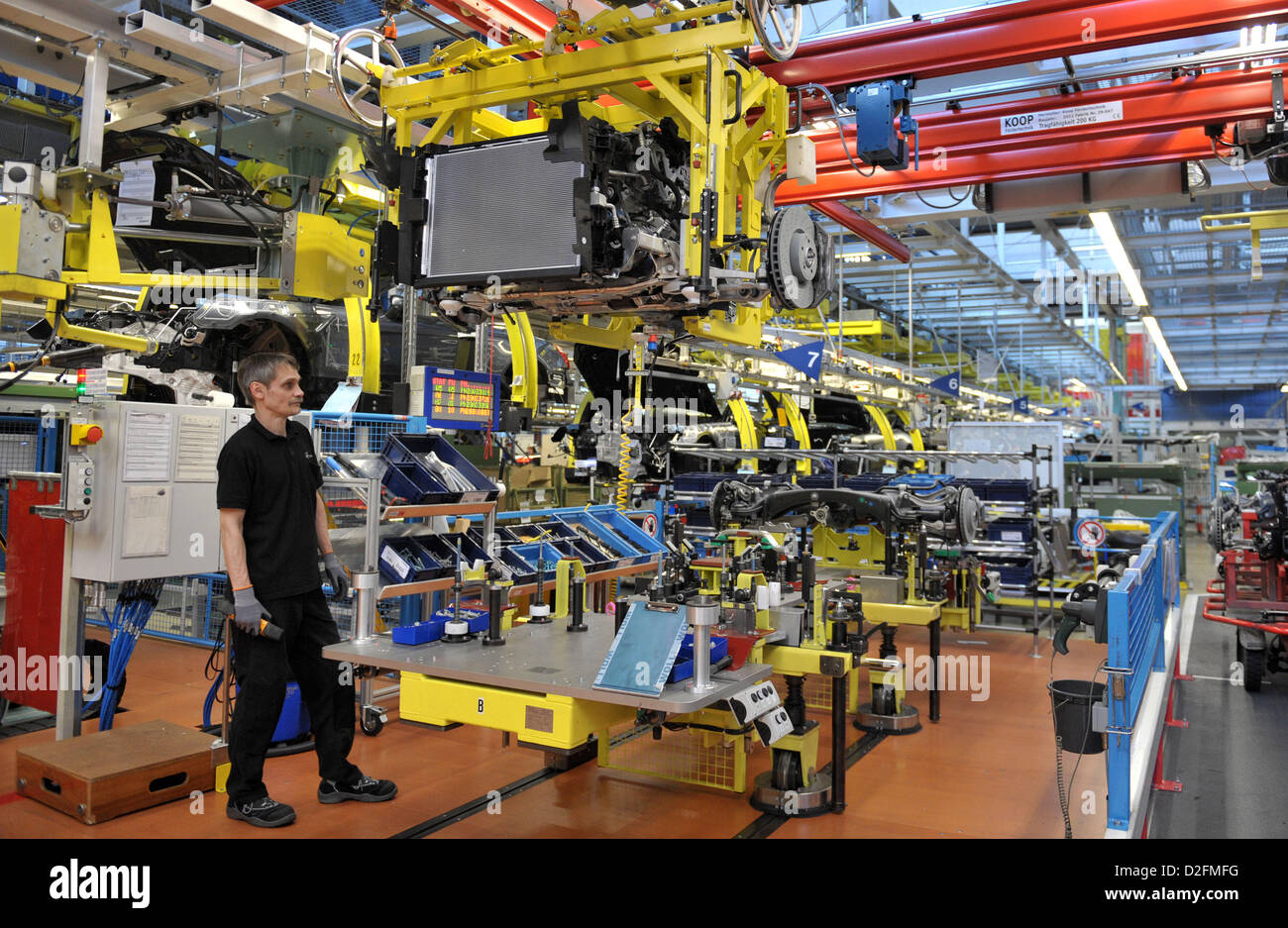 An employee is standing next to the engine of the new Mercedes-Benz SL ...