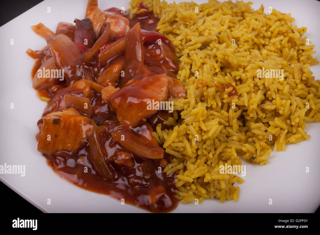 Close up photo of BBQ chicken with rice on white plate Stock Photo - Alamy