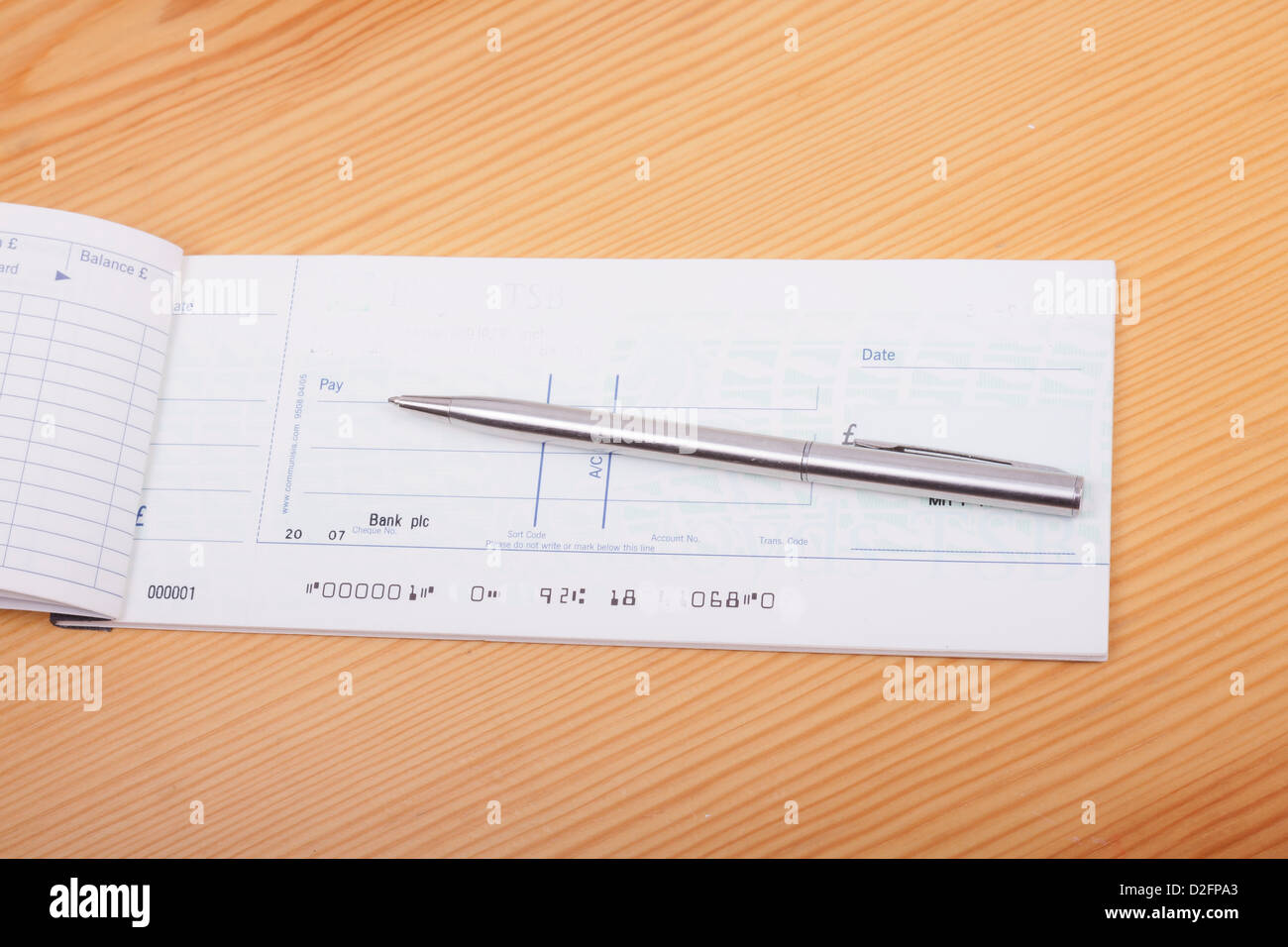 Check book and pen Stock Photo - Alamy