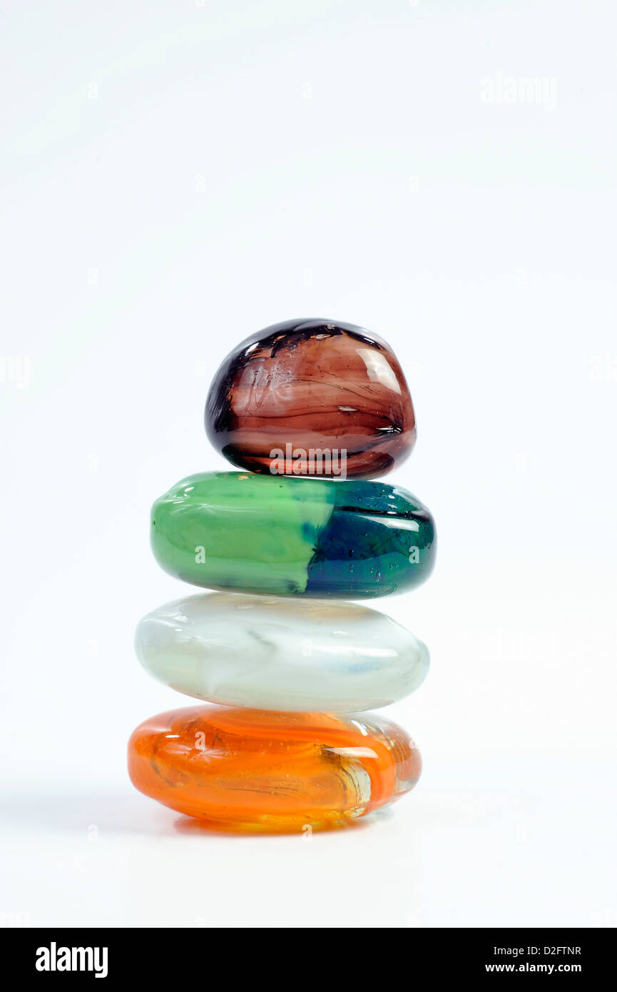 Stack of colorful transparent pebbles, white background Stock Photo - Alamy