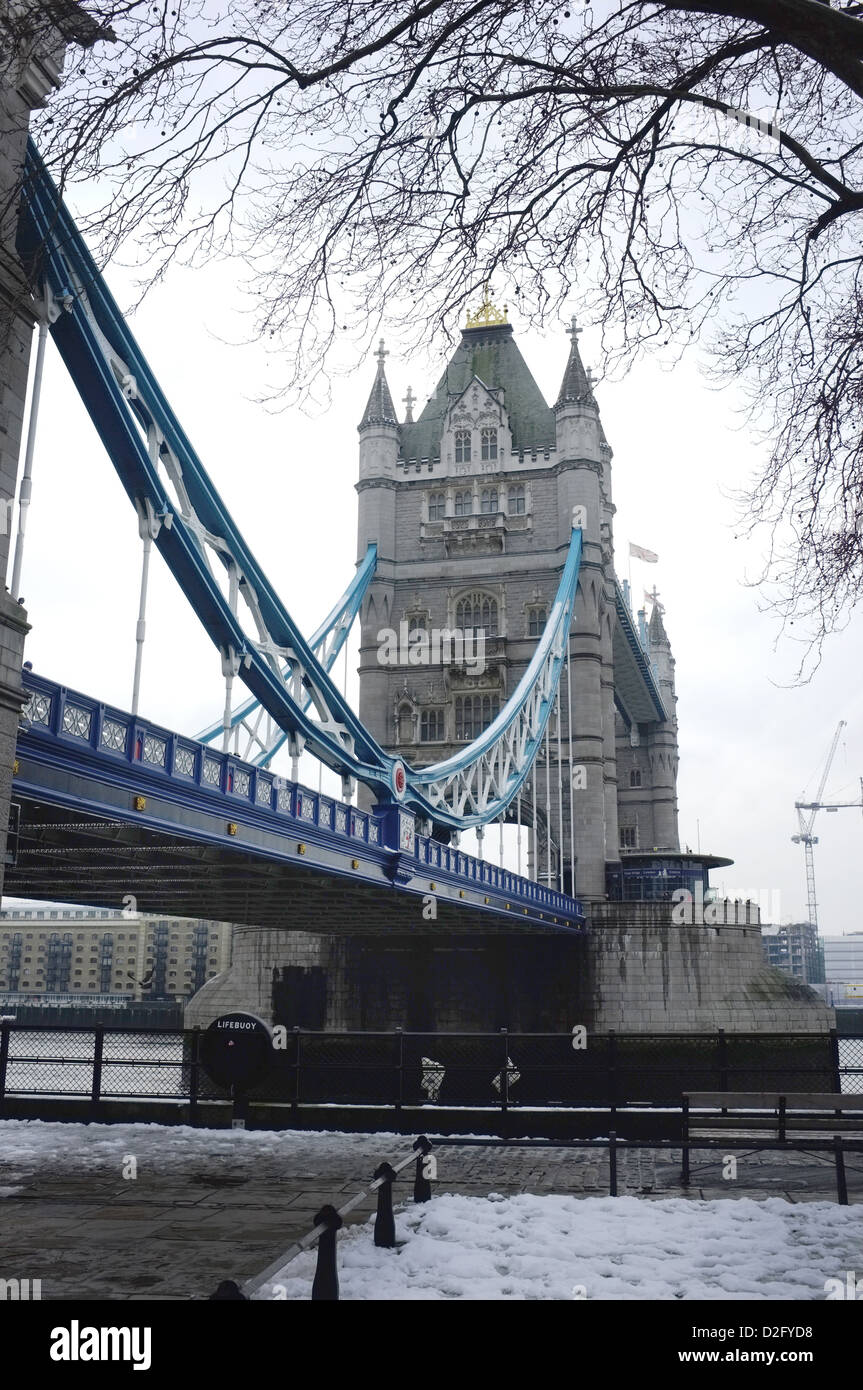 Tower Bridge, cold metal and stone framed by snowy ground and bare ...