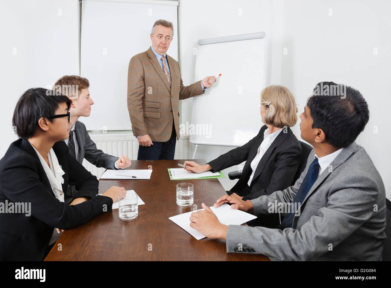 Man using whiteboard in business meeting Stock Photo - Alamy