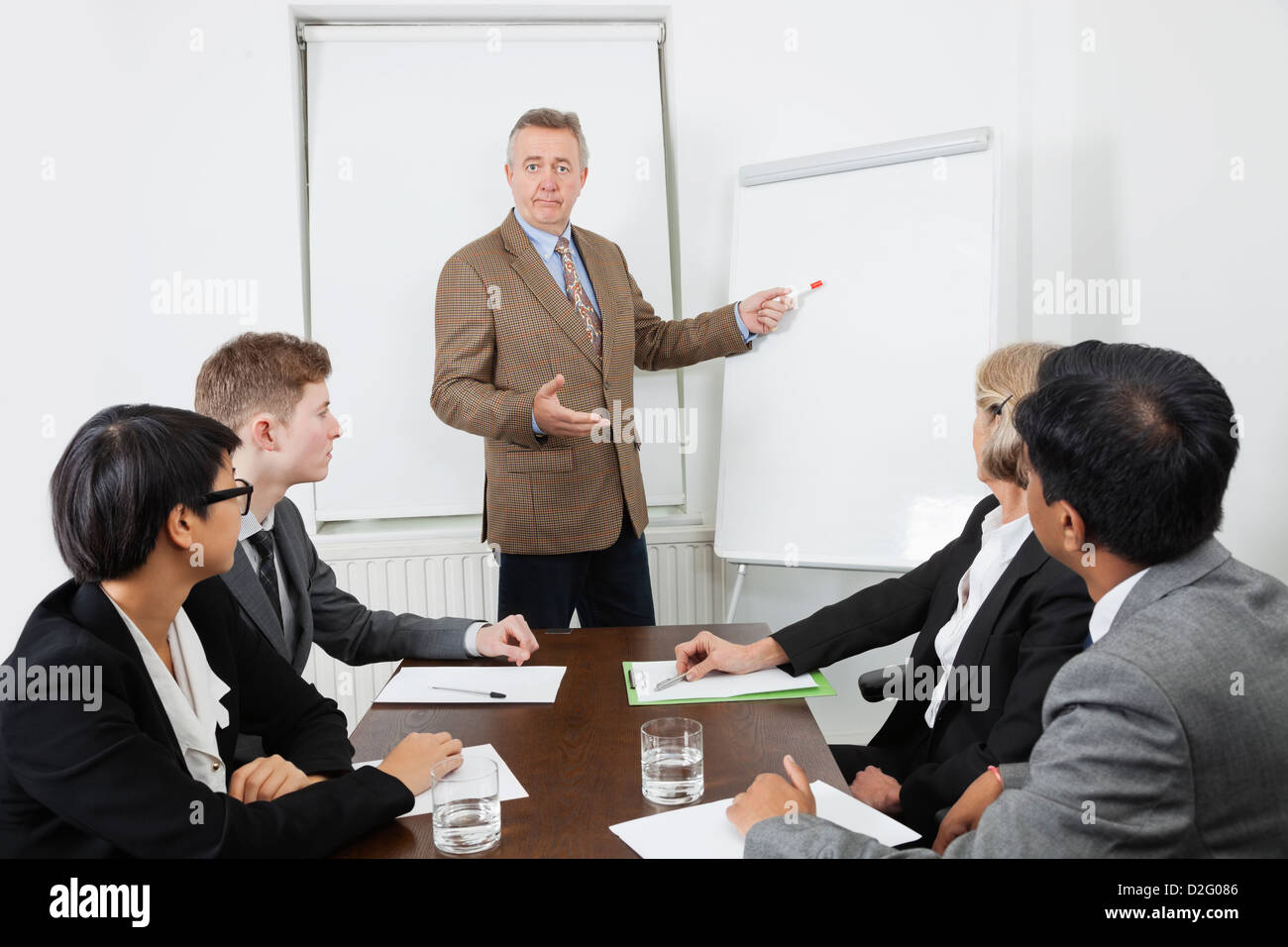 Man using whiteboard in business meeting Stock Photo - Alamy
