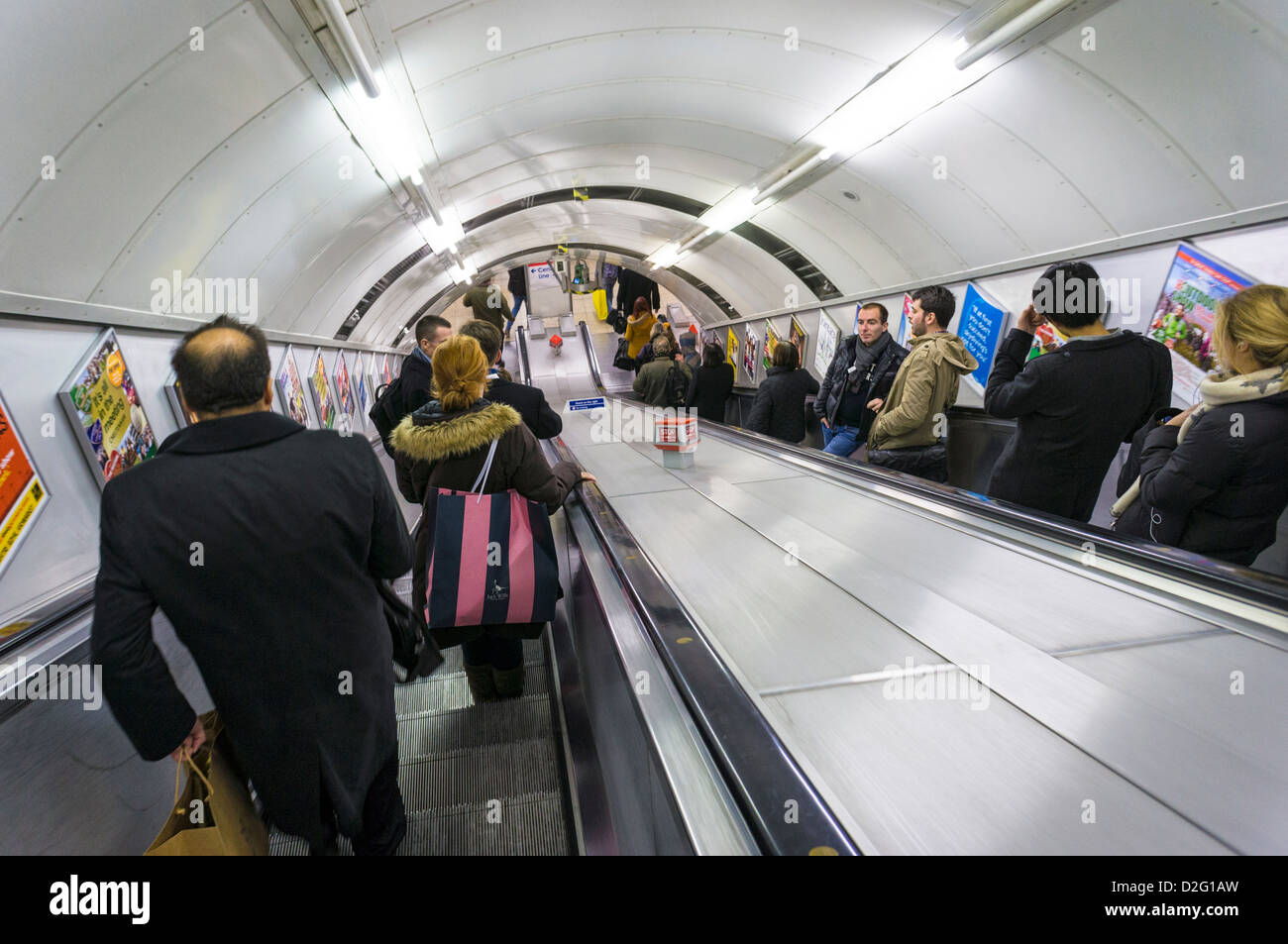 London tube escalator, with people going down the London underground ...
