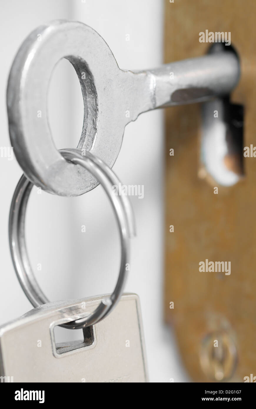Macro photo of old style house key in door lock Stock Photo - Alamy