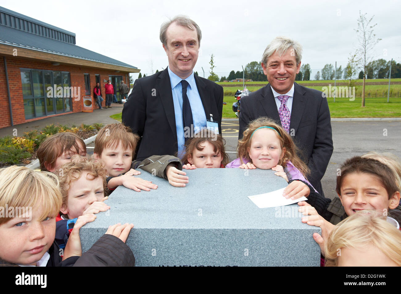 Keneth Bannerman (L) and John Bercow pose with local school children at ...
