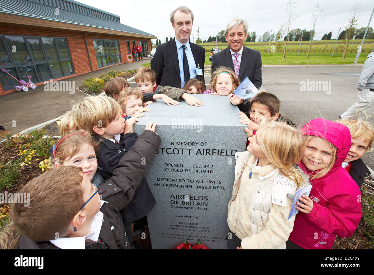 Keneth Bannerman (L) and John Bercow pose with local school children at ...
