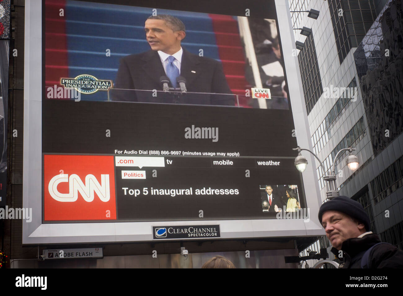 Passer-by gather in Times Square in New York to watch the inauguration ...