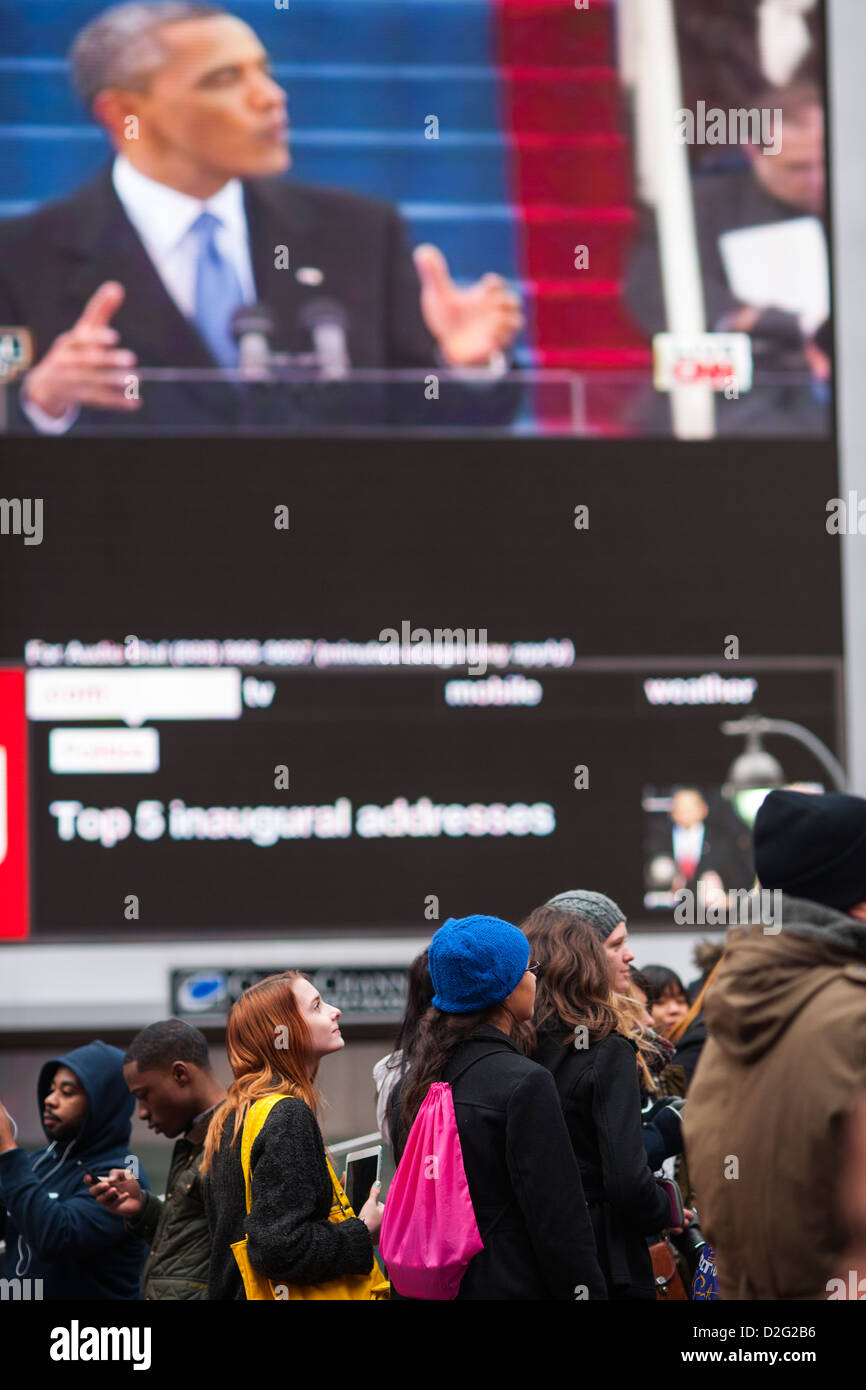 Passer-by gather in Times Square in New York to watch the inauguration ...