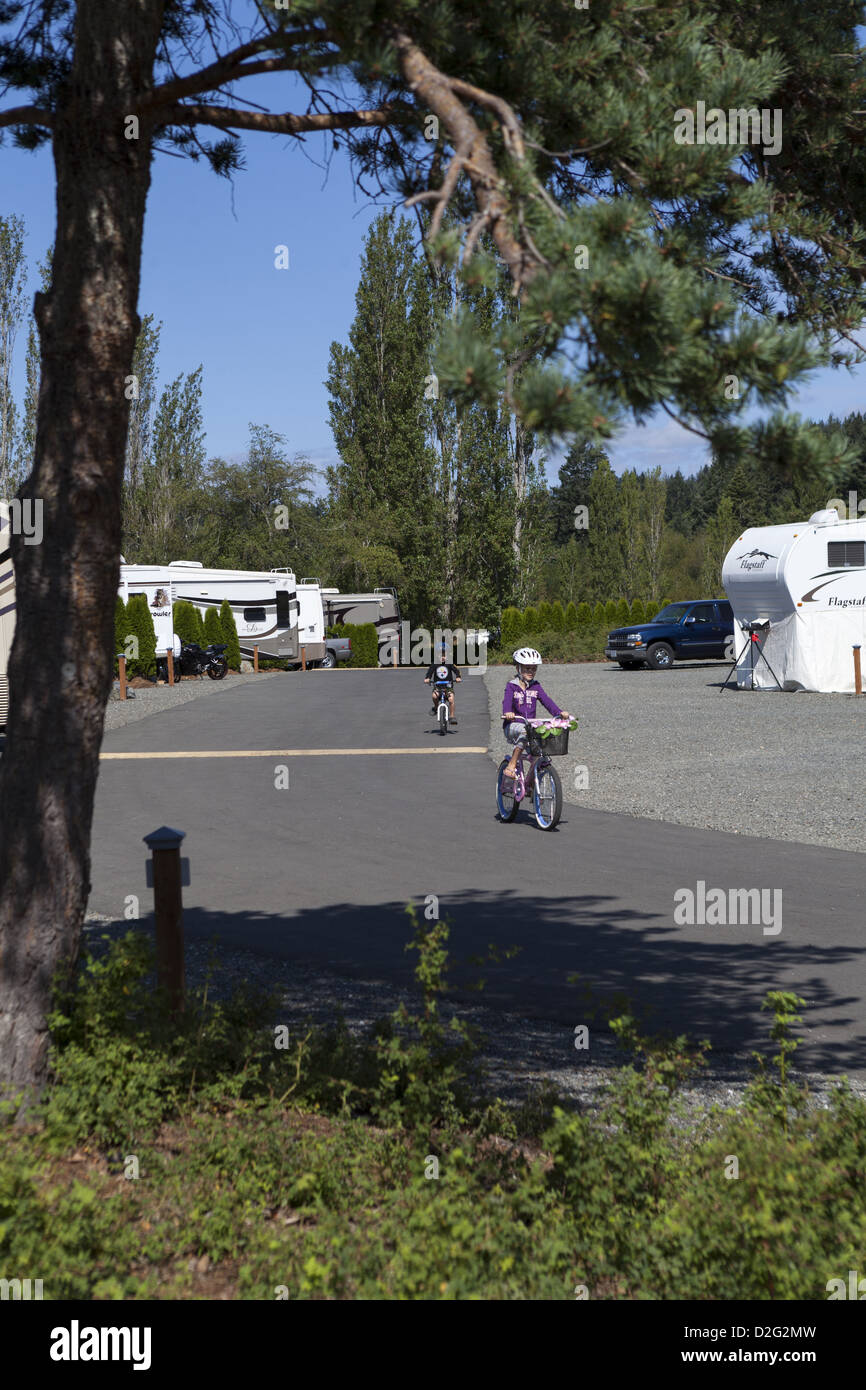 Kids riding bicylces around a RV park in Pedder Bay RV Resort and ...